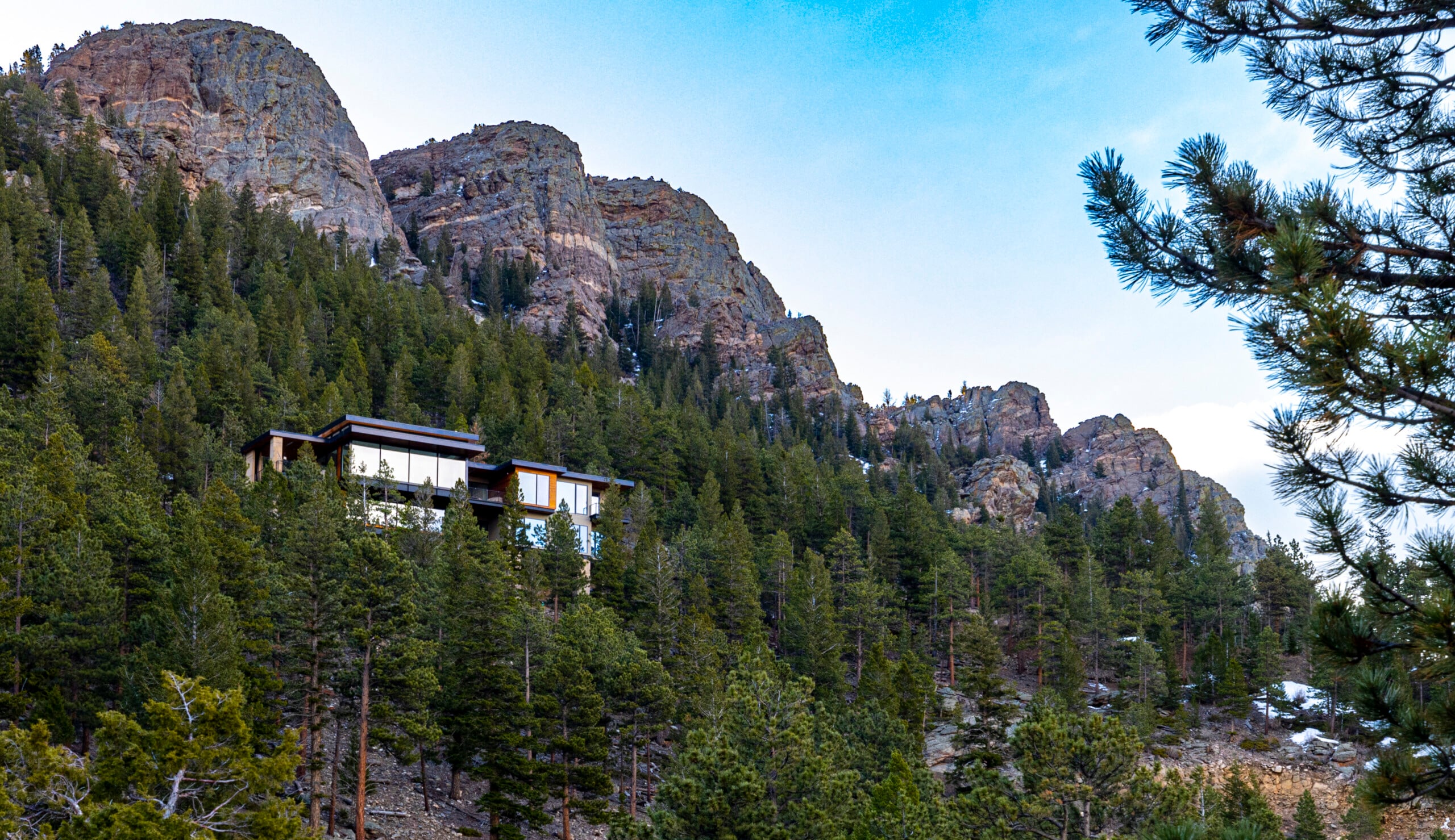 A Cliff Dwelling Home Overlooks the Expansive Views of Rocky Mountain ...